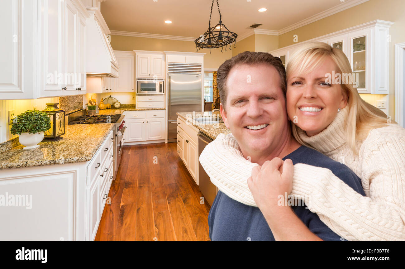 Happy Couple Hugging Inside Beautiful Custom Kitchen Stock Photo - Alamy