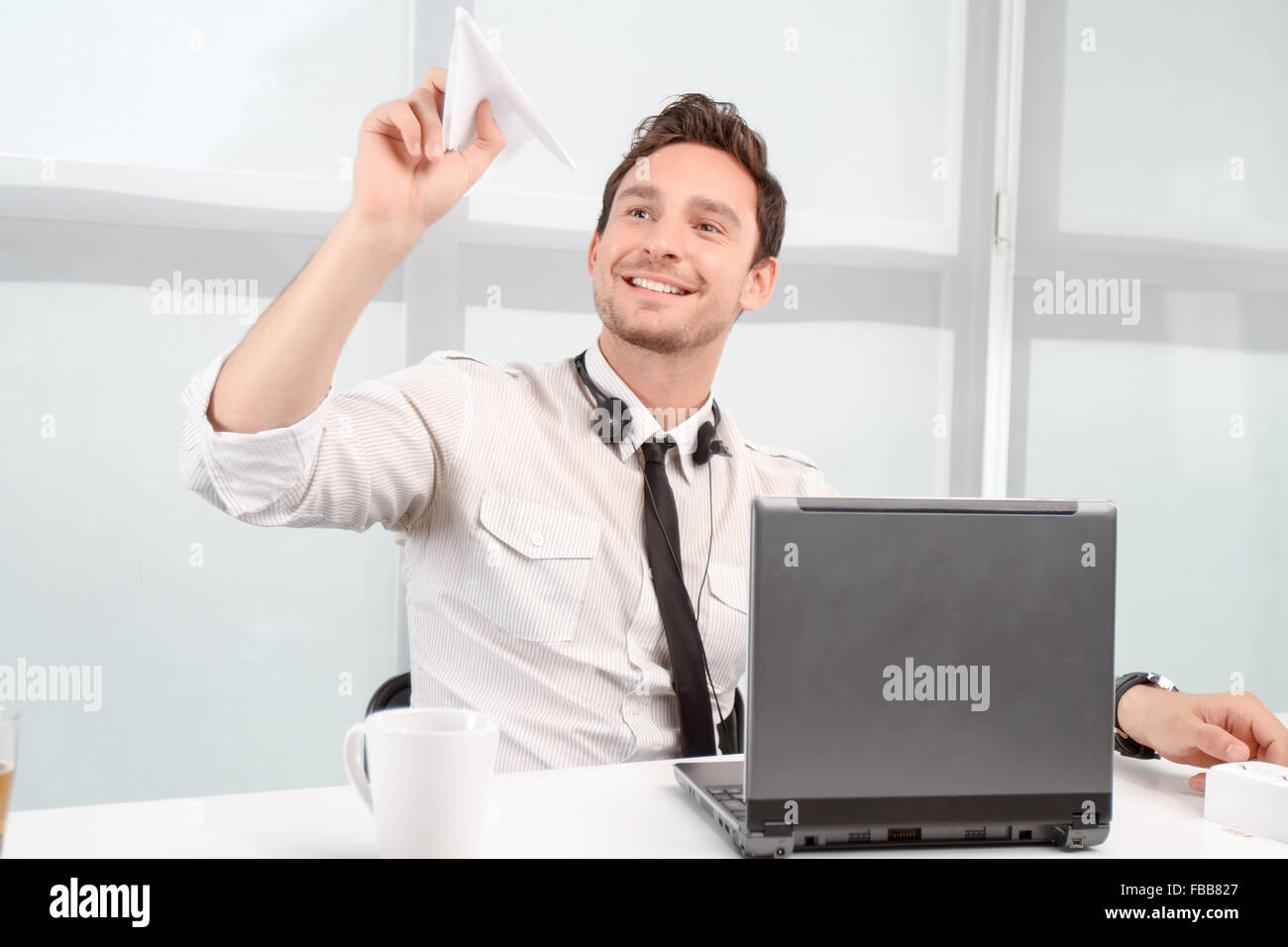 Positive call center operator holding paper plane Stock Photo - Alamy