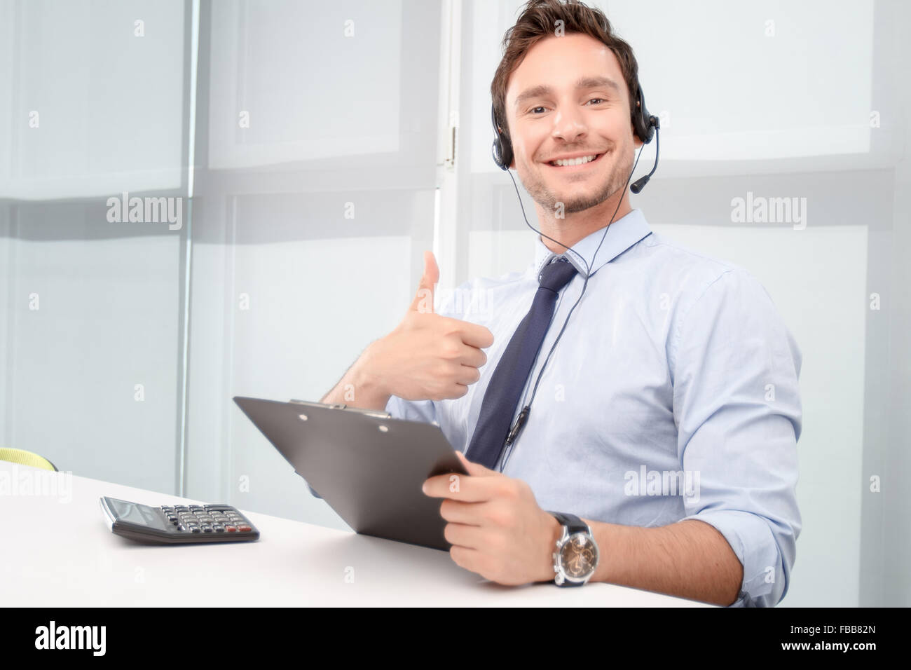 Call center operator counting on calculator Stock Photo - Alamy