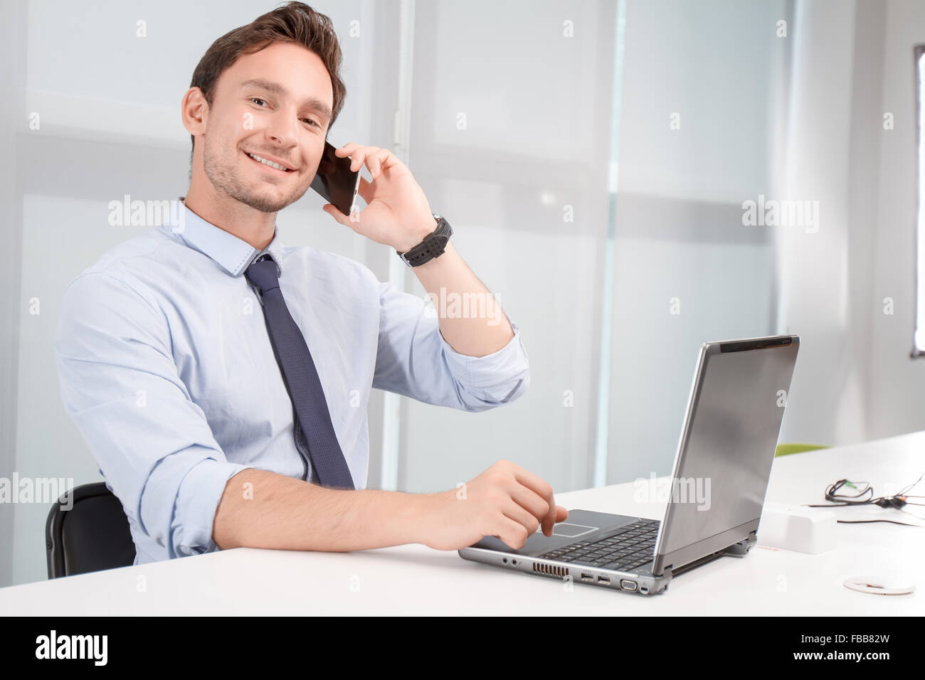 Call center operator holding mobile phone Stock Photo - Alamy