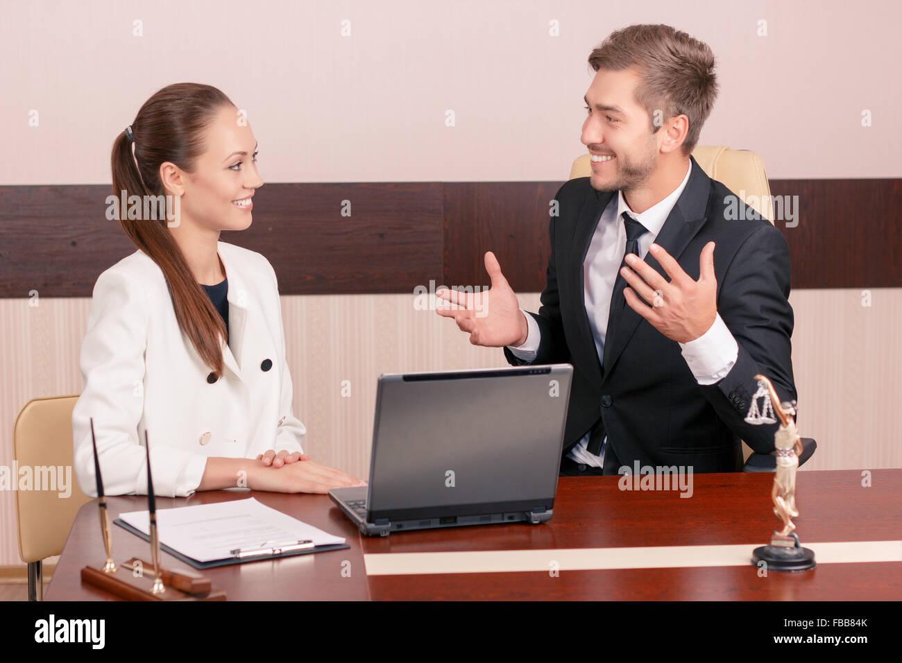 Nice lawyer talking with colleague Stock Photo - Alamy