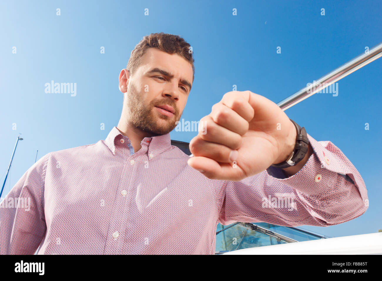 Handsome man watching time Stock Photo - Alamy