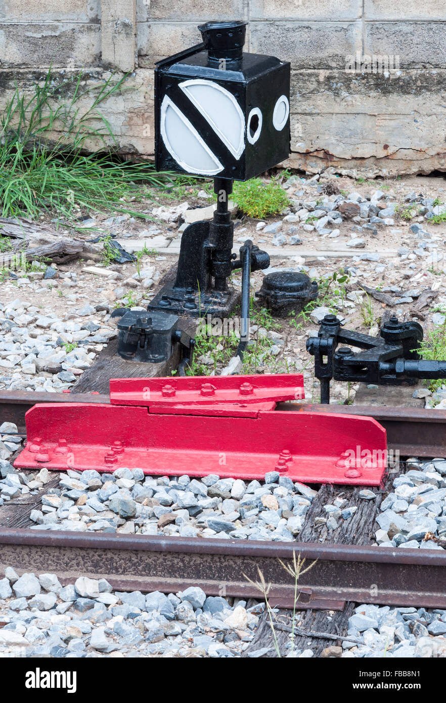 Derailer tool on the rusty railway of urban station Stock Photo - Alamy