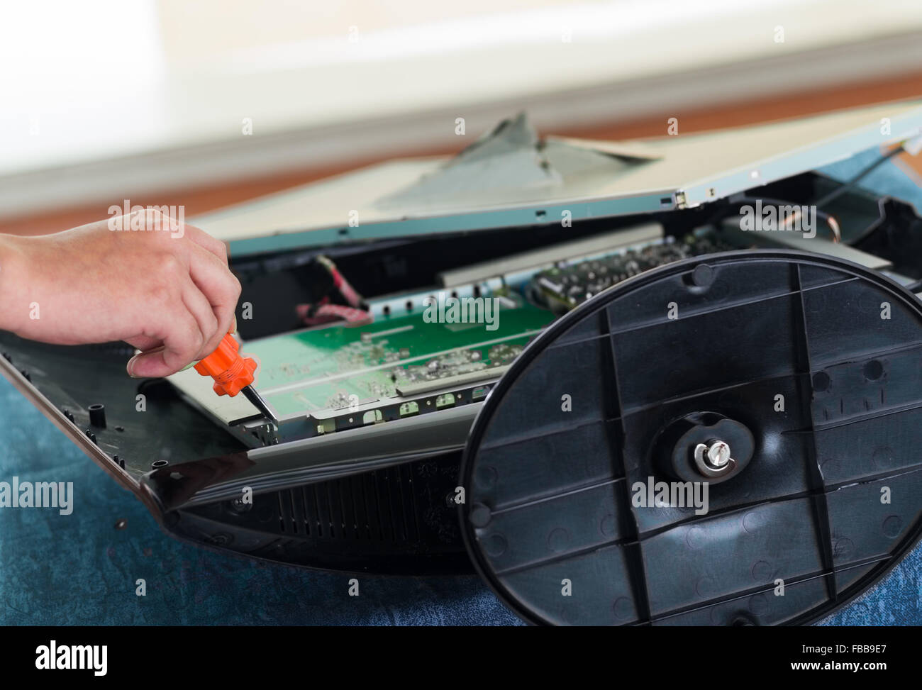 Hands working with electronic circuit board from broken computer screen ...