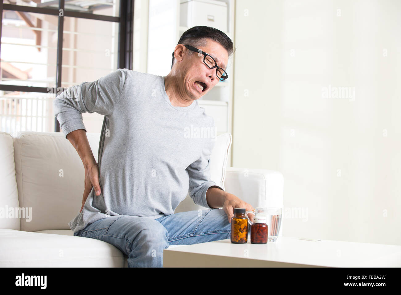asian senior male with back pain Stock Photo - Alamy