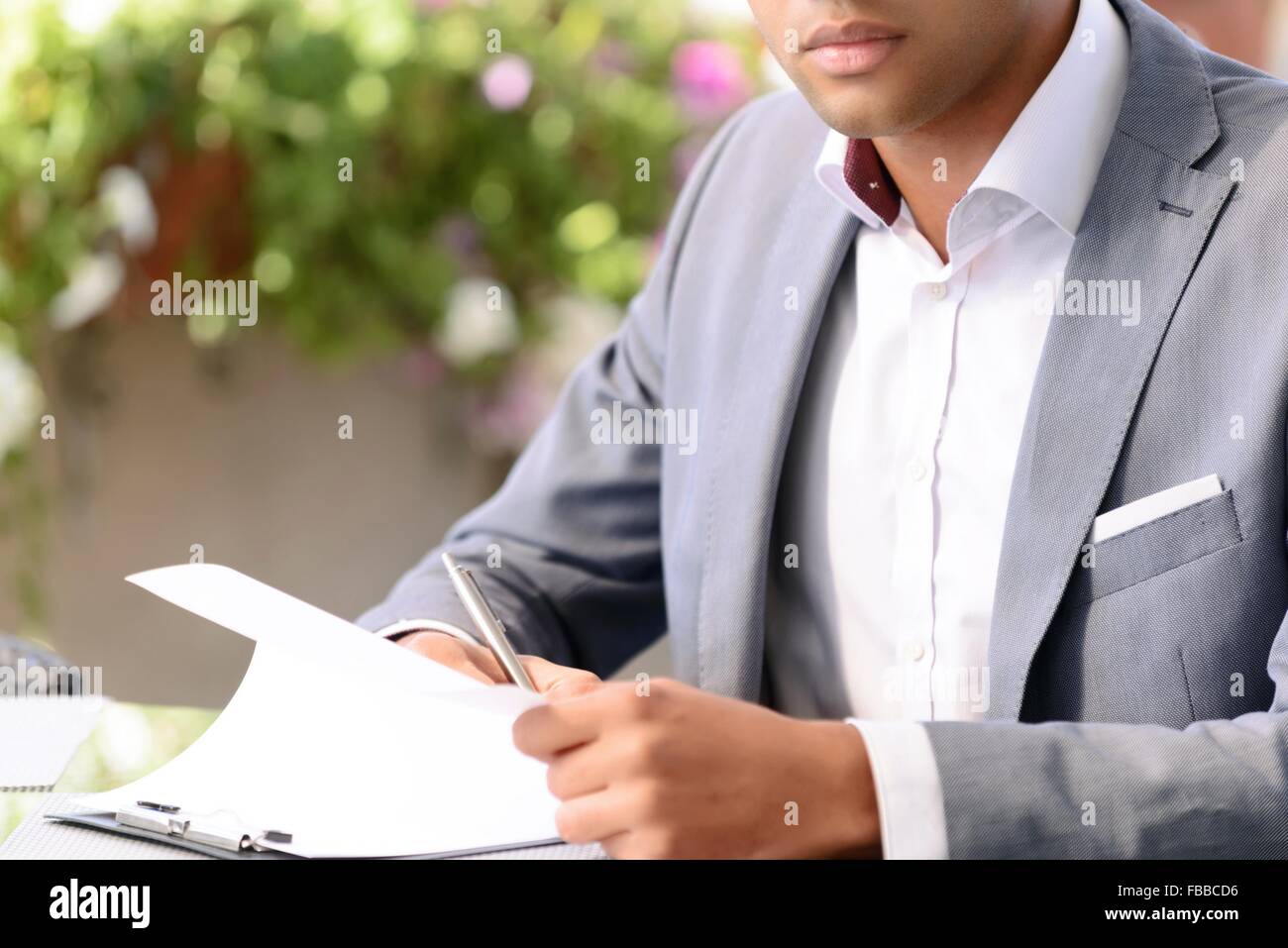 Handsome businessman making notes Stock Photo - Alamy
