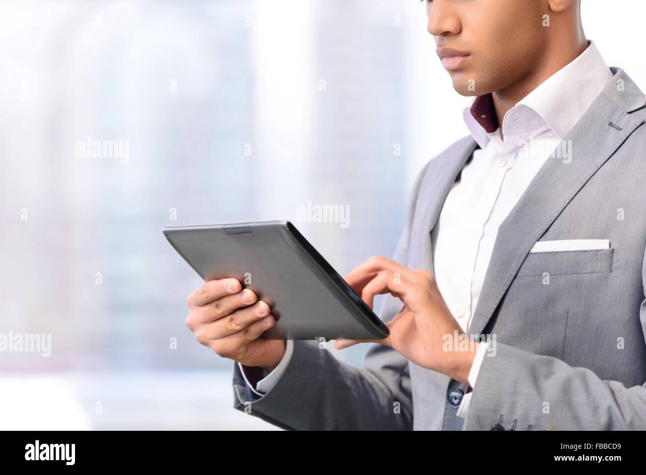 Handsome businessman holding laptop Stock Photo - Alamy