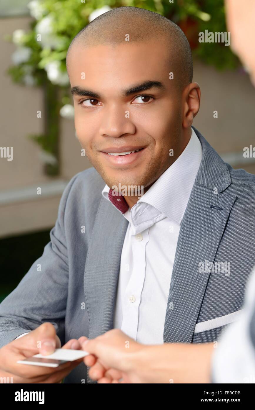 Nice man giving credit card Stock Photo - Alamy