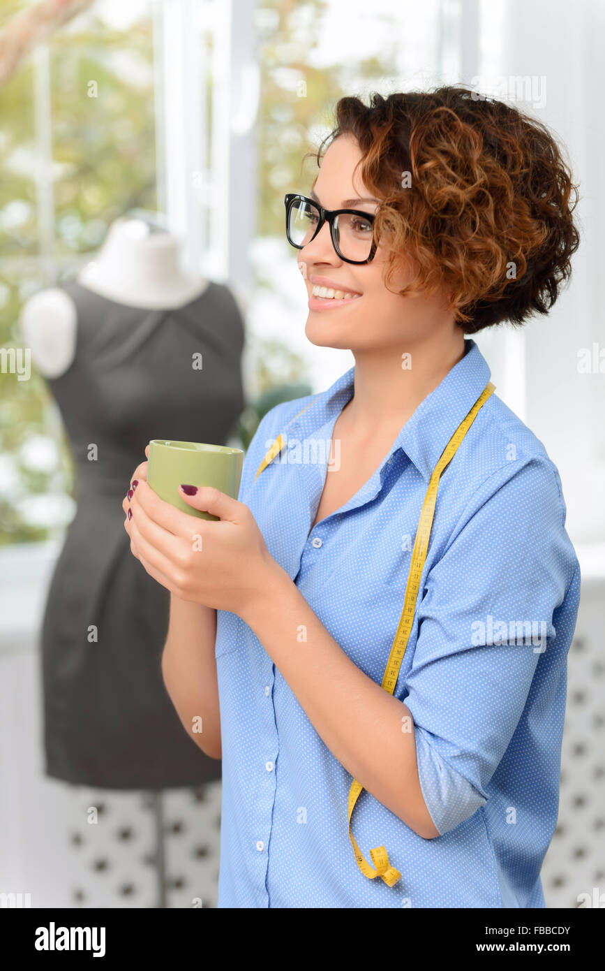 Nice designer drinking tea Stock Photo - Alamy
