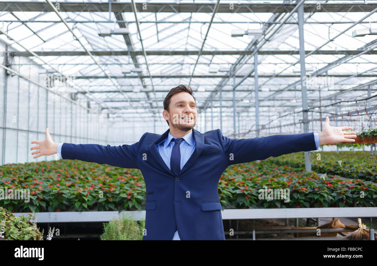 Pleasant greenhouse owner controlling his business Stock Photo - Alamy