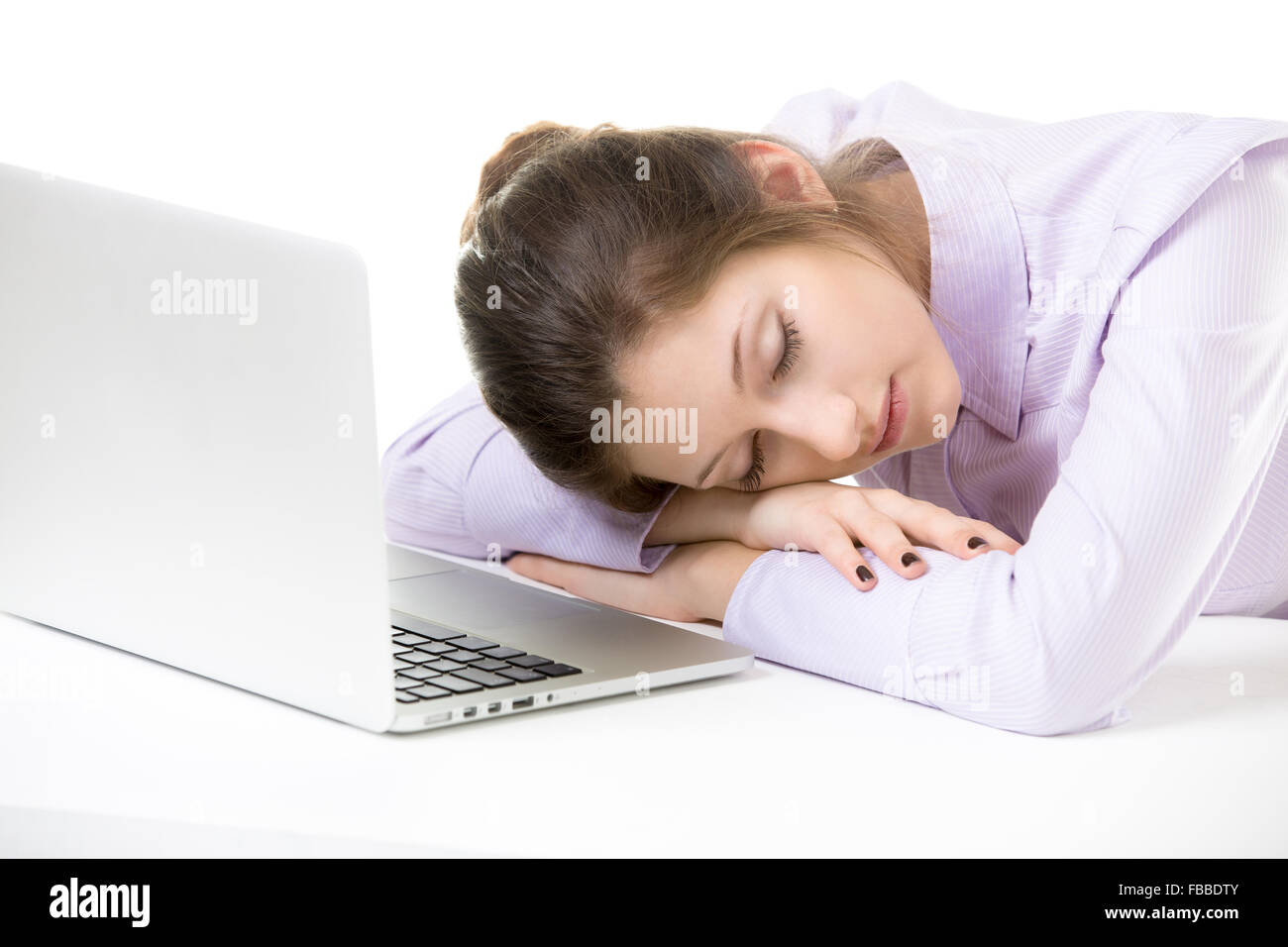 Worn-out young woman taking a nap, tired from work, sleeping in front ...