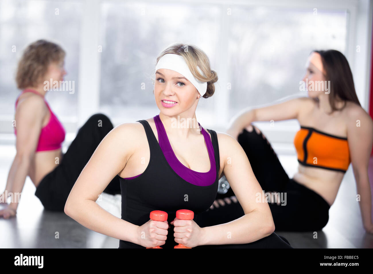 Beautiful smiling girl enjoy fitness exercises with dumbbells, workout ...