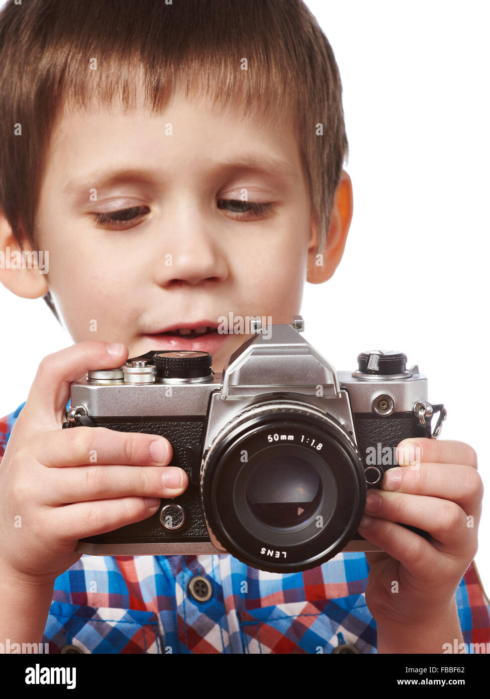 Little boy reporter photographer with SLR camera isolated close-up ...