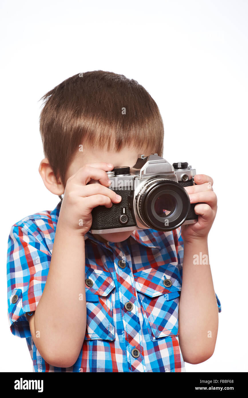 Little boy reporter photographer shooting with SLR camera isolated ...
