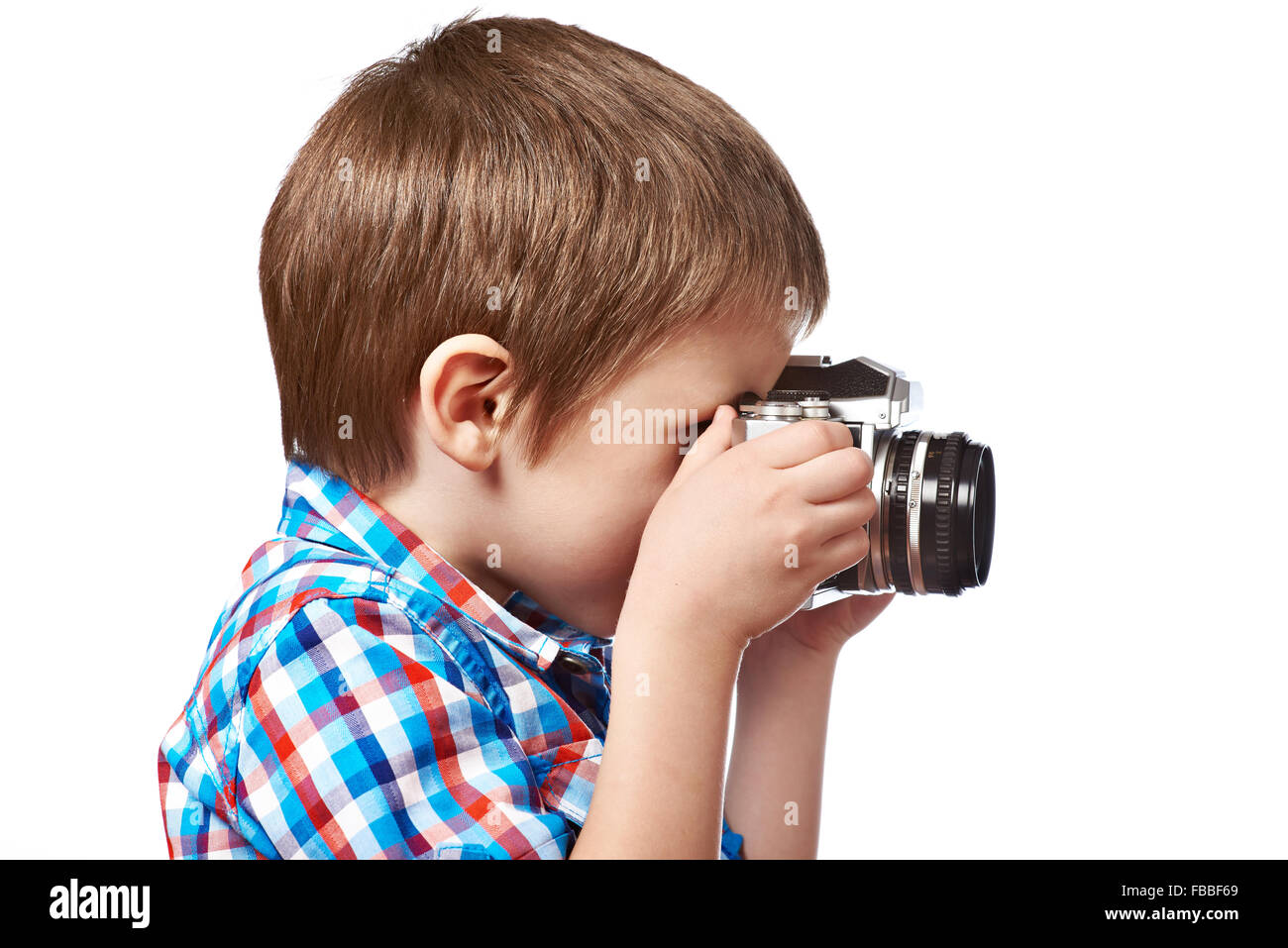 Little boy photographer shooting with SLR camera isolated close-up ...