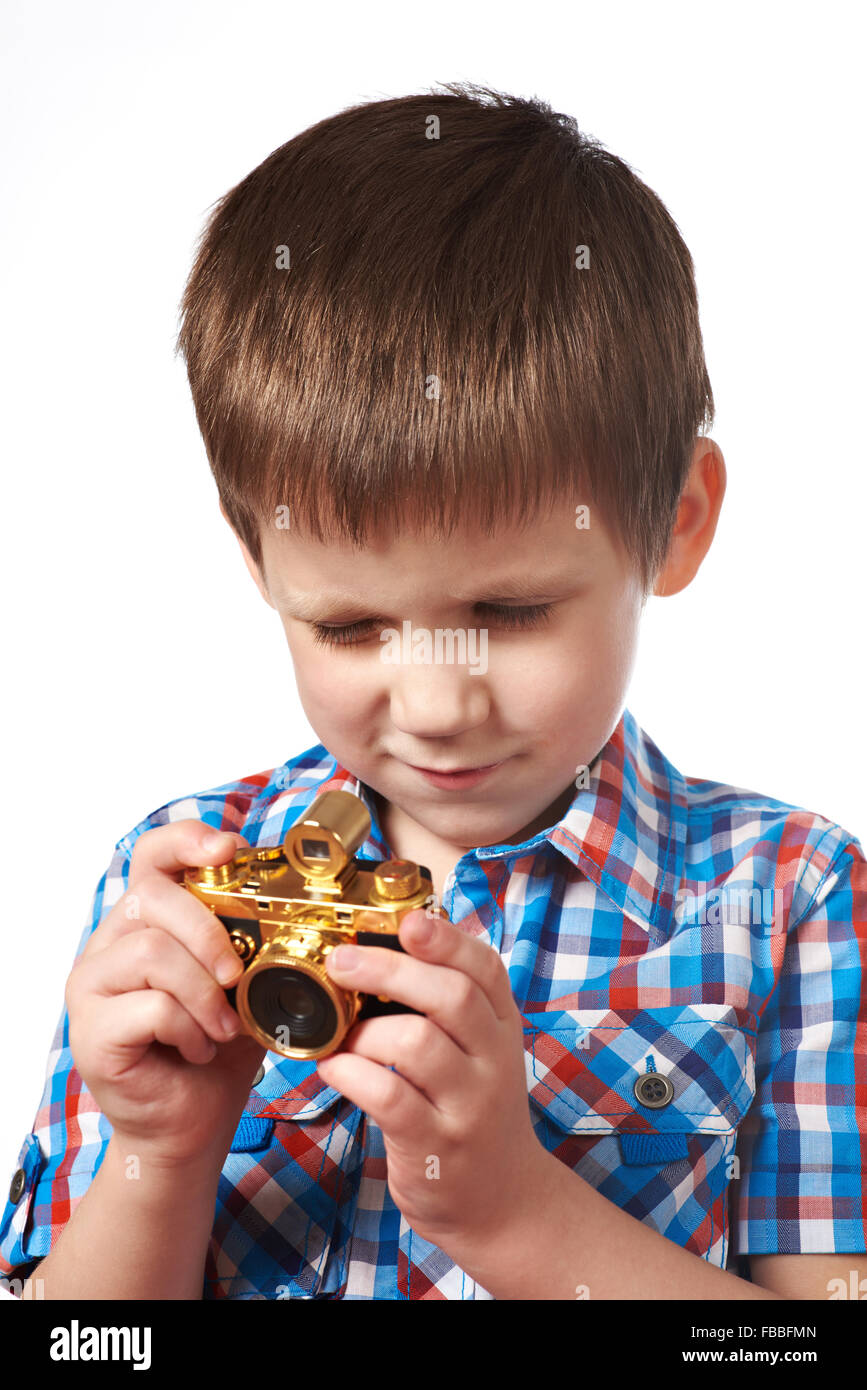 Little boy reporter photographer shooting with gold retro camera ...