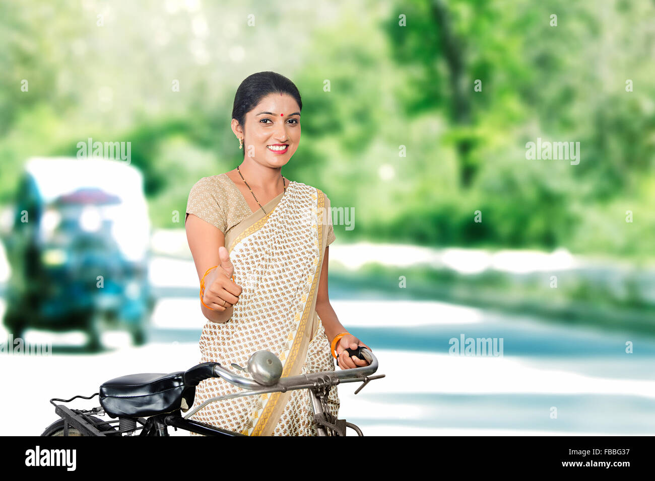 1 indian rural villager woman Riding Bicycle and thumbs up showing ...