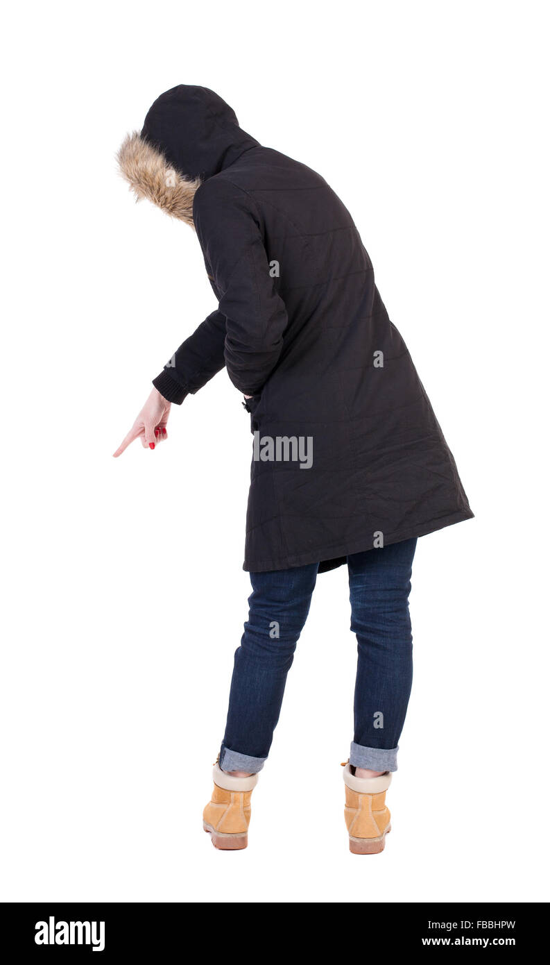 Back view of pointing young women in parka. Young girl gesture. Rear ...