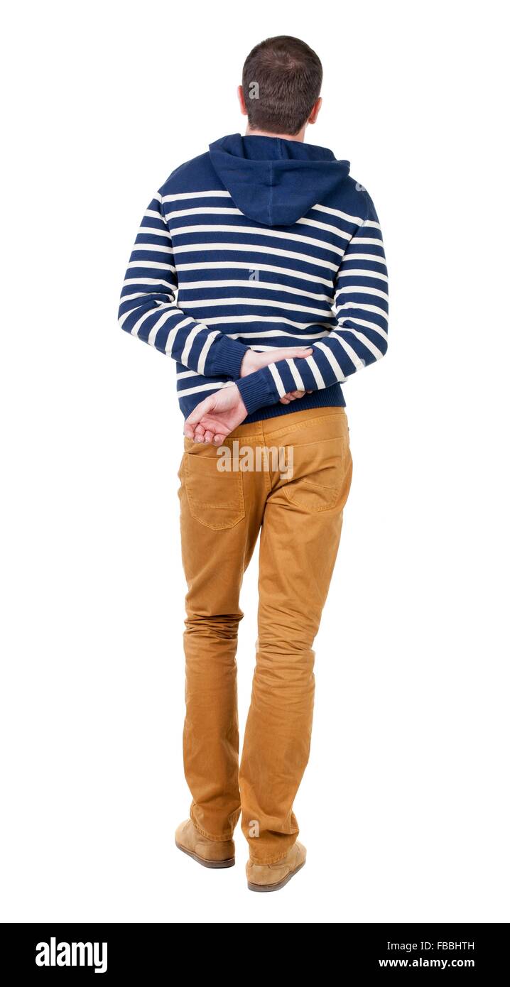 Back view of handsome man in striped hooded sweater. Standing young guy ...