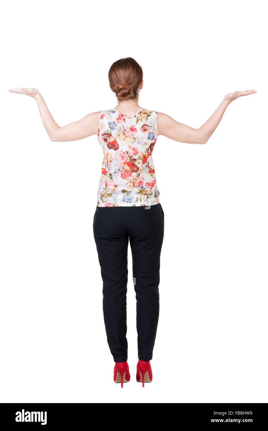 Back view of Beautiful business woman in suite looking at wall and ...