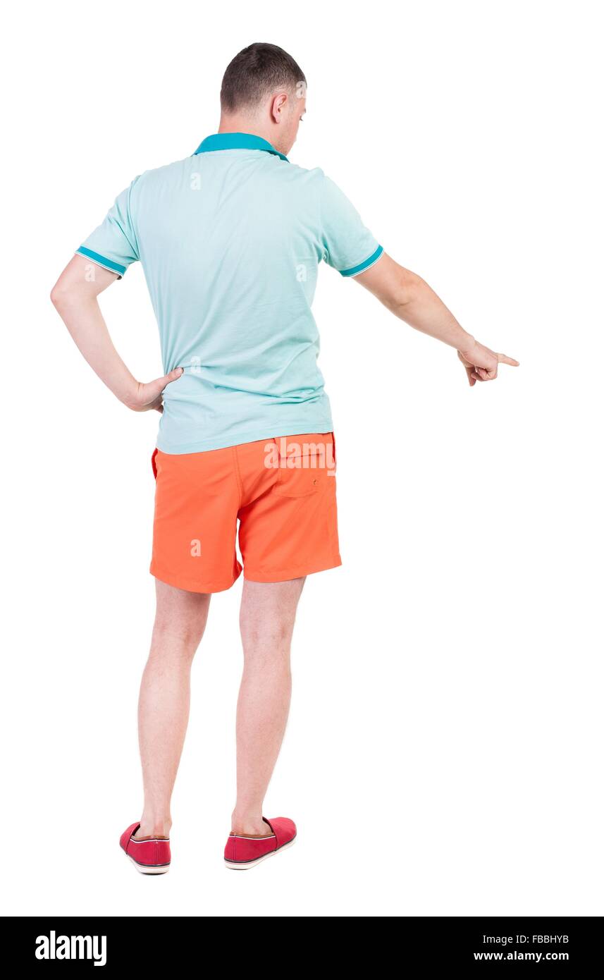 Back view of pointing young men in t-shirt and shorts. Young guy ...