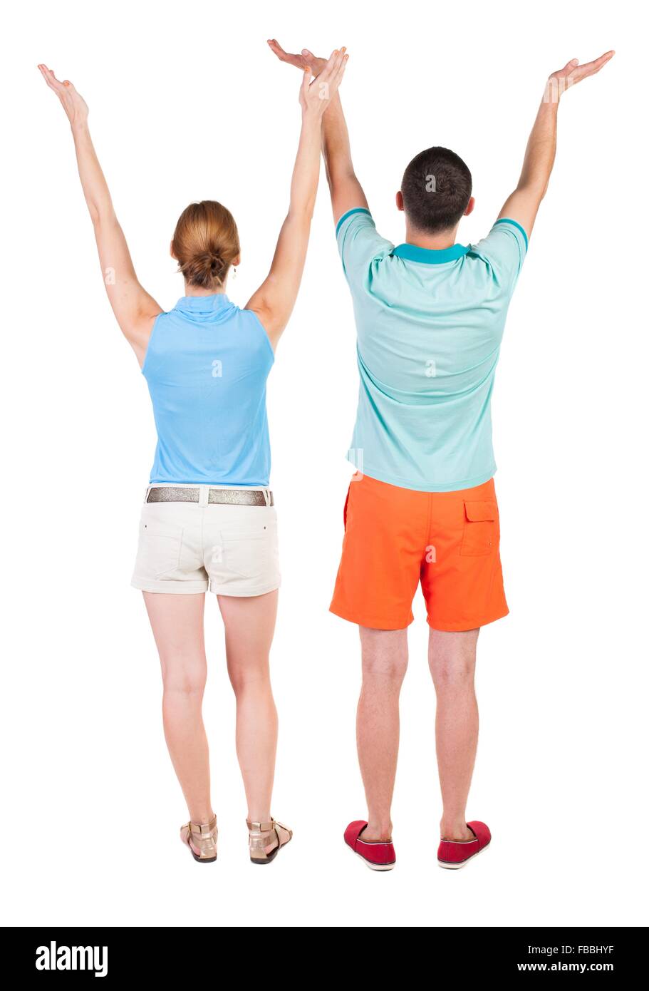 Back view couple looking at wall and Holds hand up. Rear view people ...