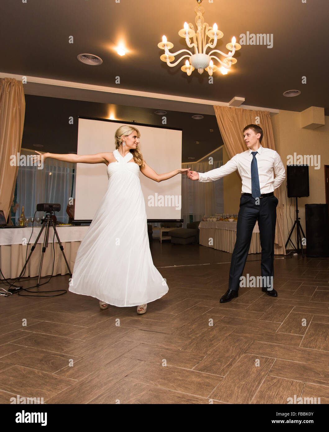 beautiful caucasian couple just married and dancing their first dance ...