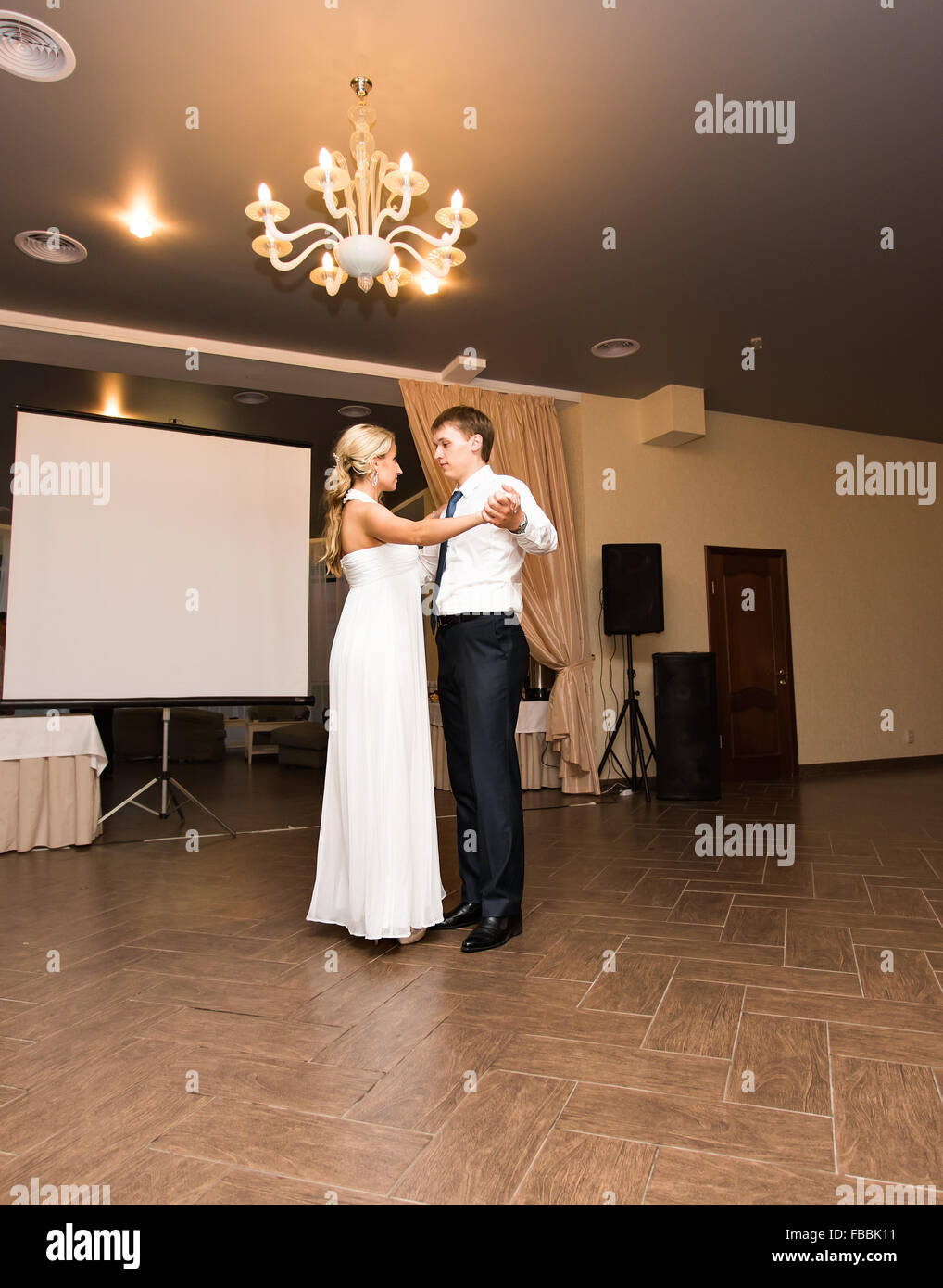 beautiful caucasian couple just married and dancing their first dance ...