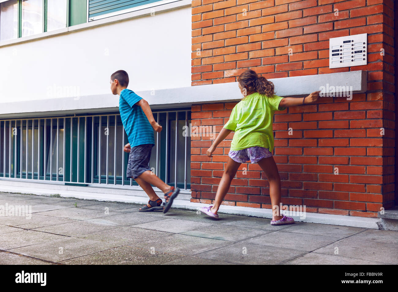 Children ring the bell and run away Stock Photo - Alamy