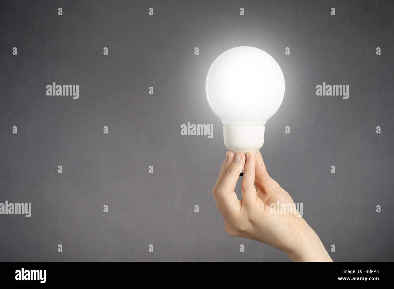 Hand holding a glowing light bulb Stock Photo - Alamy