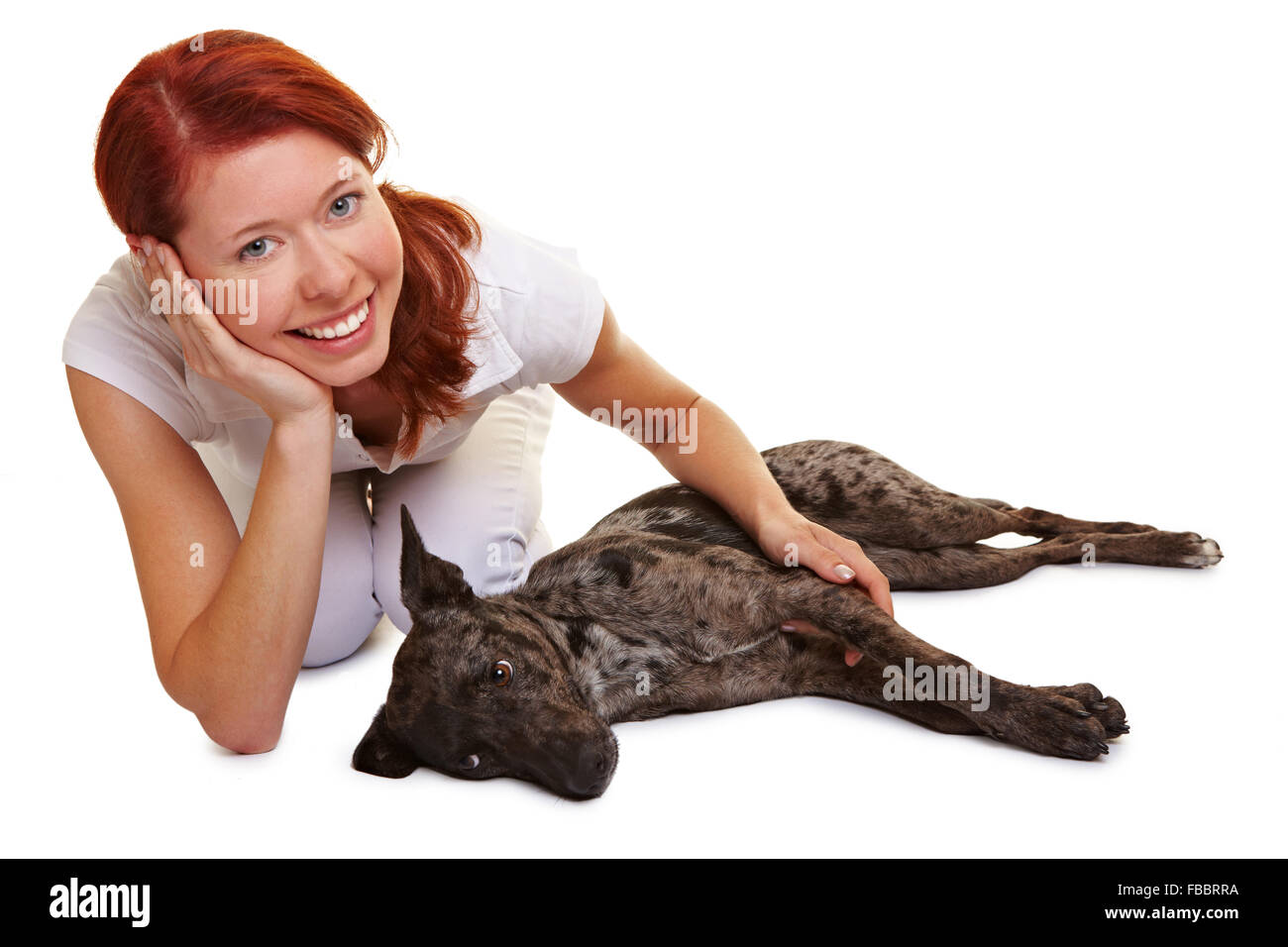 Dog laying beside smiling happy redhaired woman Stock Photo - Alamy