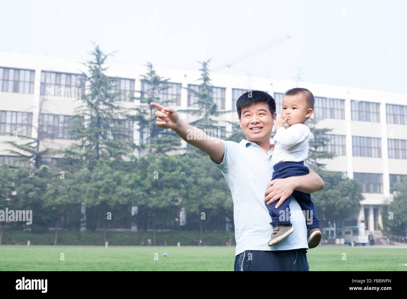 Chinese father and son pointing afar, shot in Beijing, China Stock ...