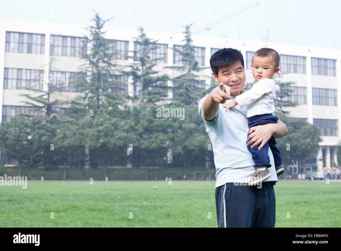 Chinese father and son pointing at camera, shot in Beijing, China Stock ...