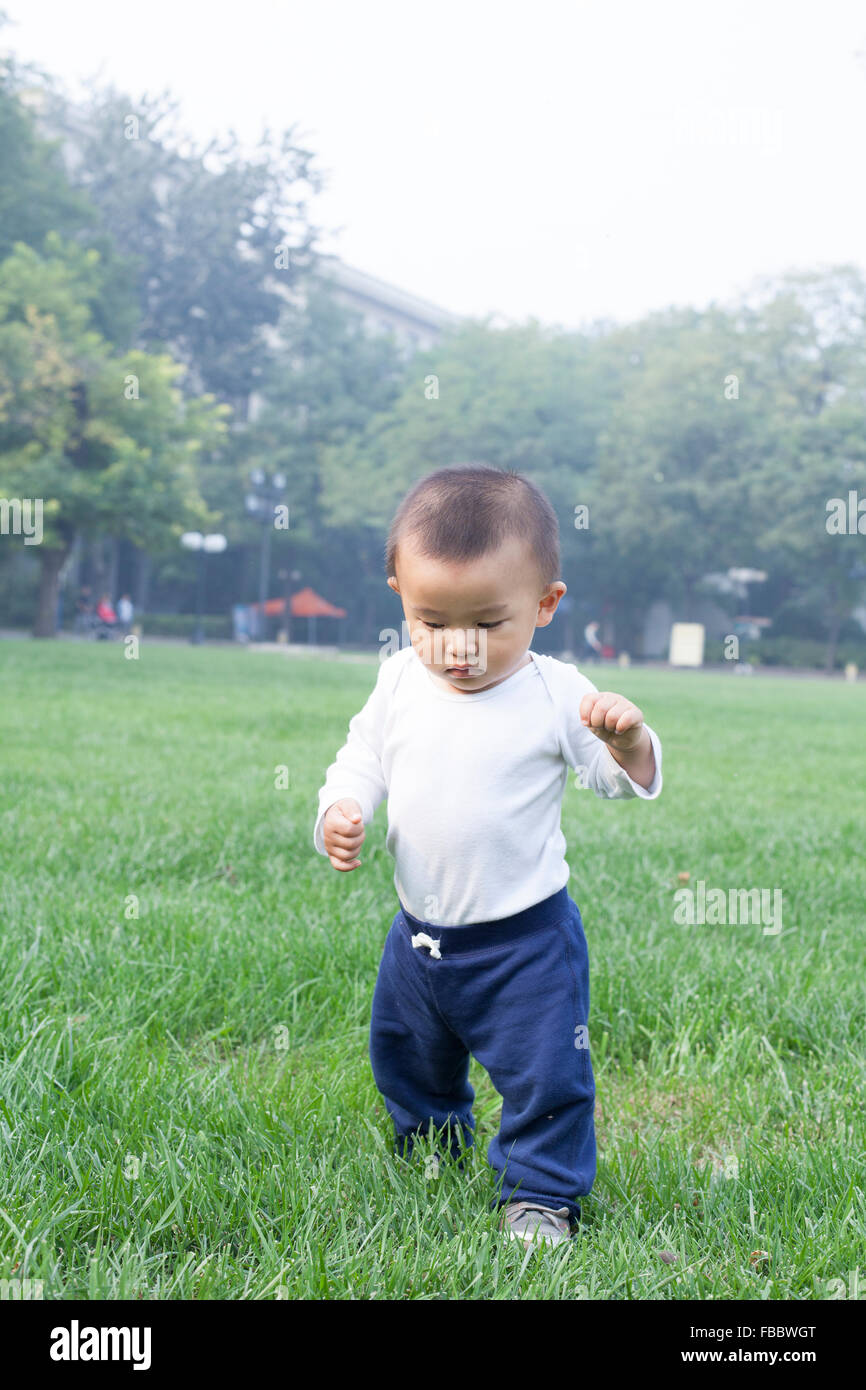 Cute Chinese baby boy running on meadow, shot in Beijing, China Stock ...