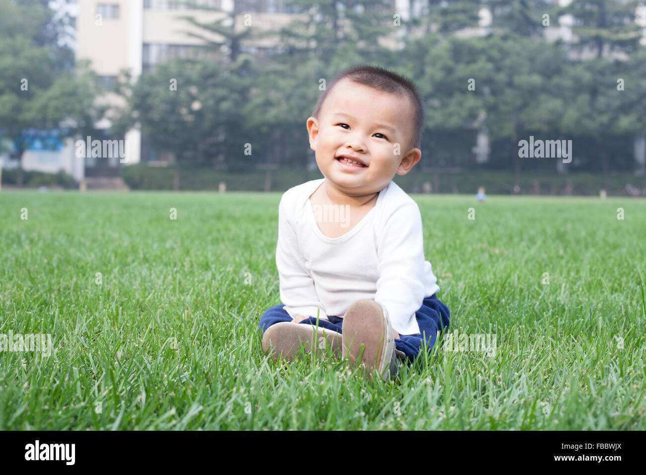 Cute Chinese baby boy sitting on meadow, shot in Beijing, China Stock ...