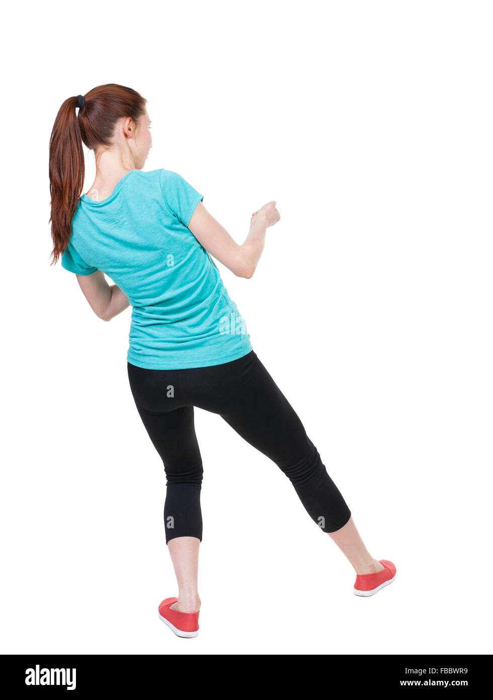 back view of woman in sportswear pulling a rope from the top or cling ...