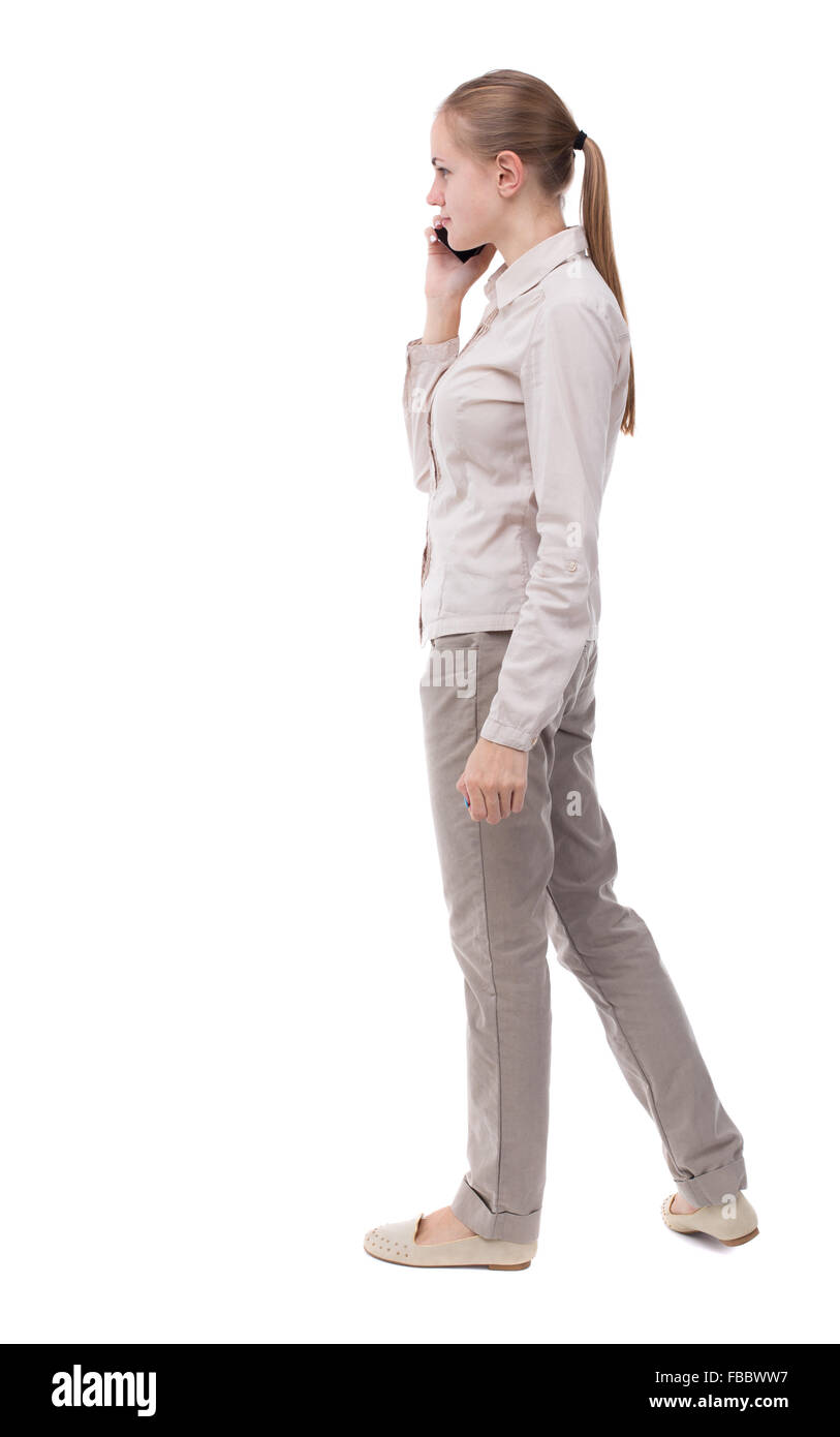 back view of a woman talking on the phone. backside view of person ...