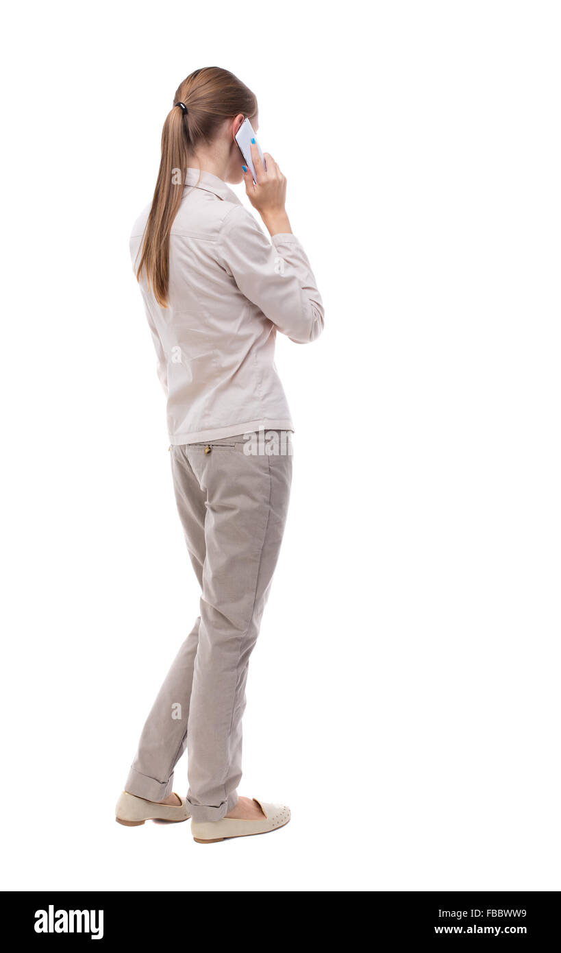 back view of a woman talking on the phone. backside view of person ...
