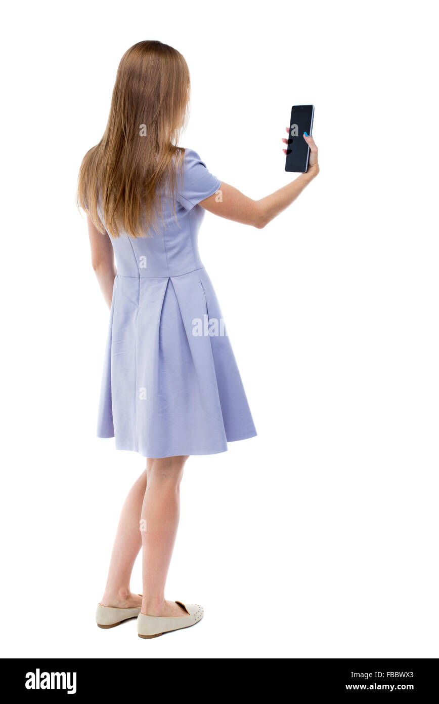 back view of standing young beautiful girl with tablet computer in the ...