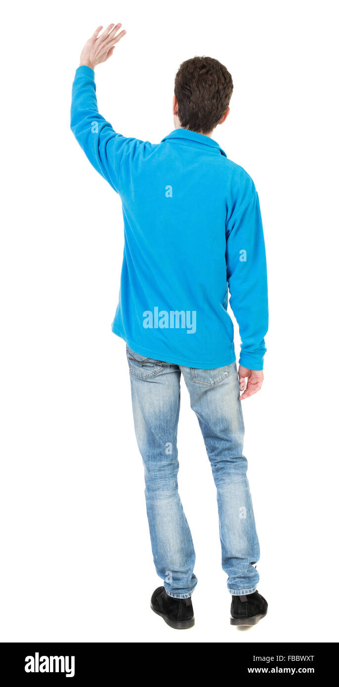 Back view of handsome man greeting waving from his hands. Standing ...