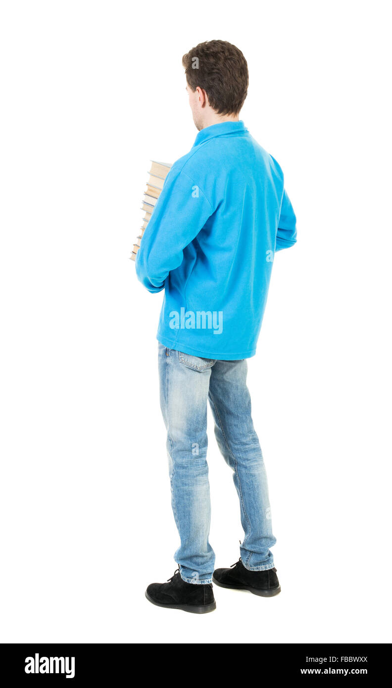 A man carries a heavy pile of books. back view. Rear view people ...