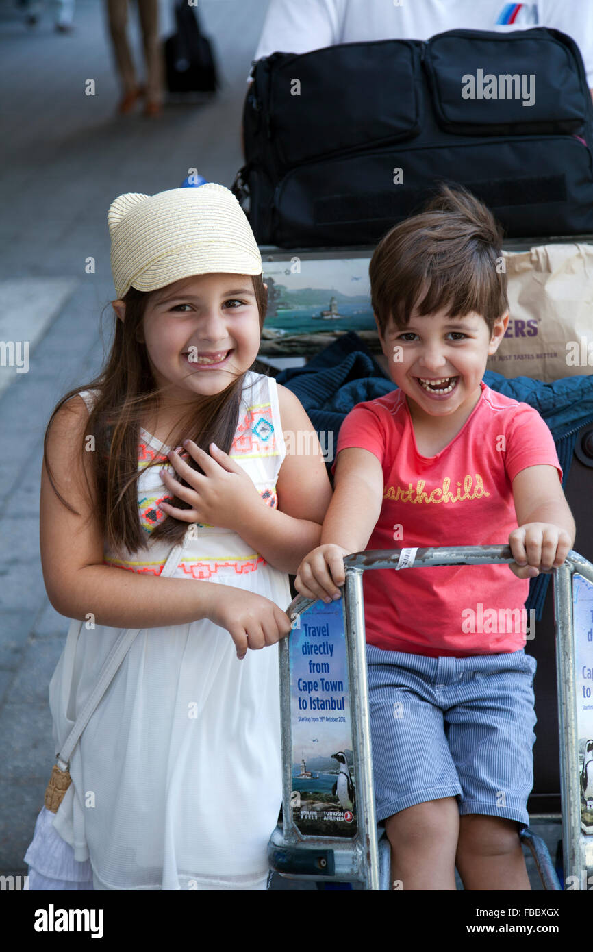 Two Happy Kids on Baggage Trolley at Cape Town International Airport in ...