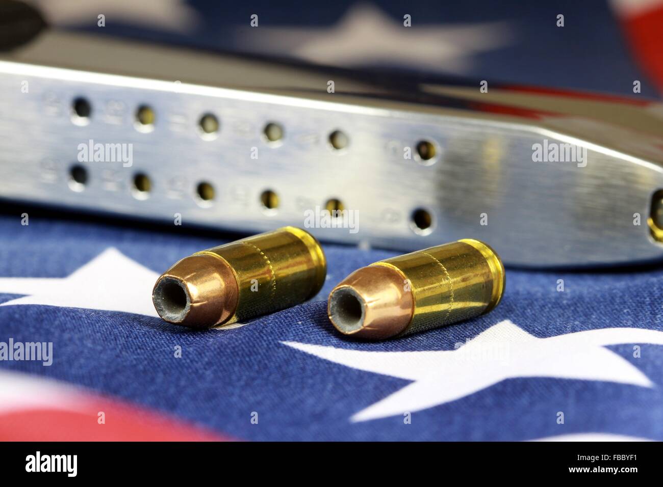 Bullets with gun clip on United States Flag Stock Photo - Alamy