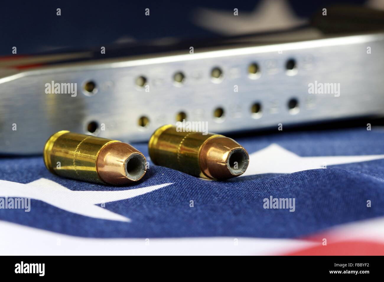 Bullets with gun clip on United States Flag Stock Photo - Alamy