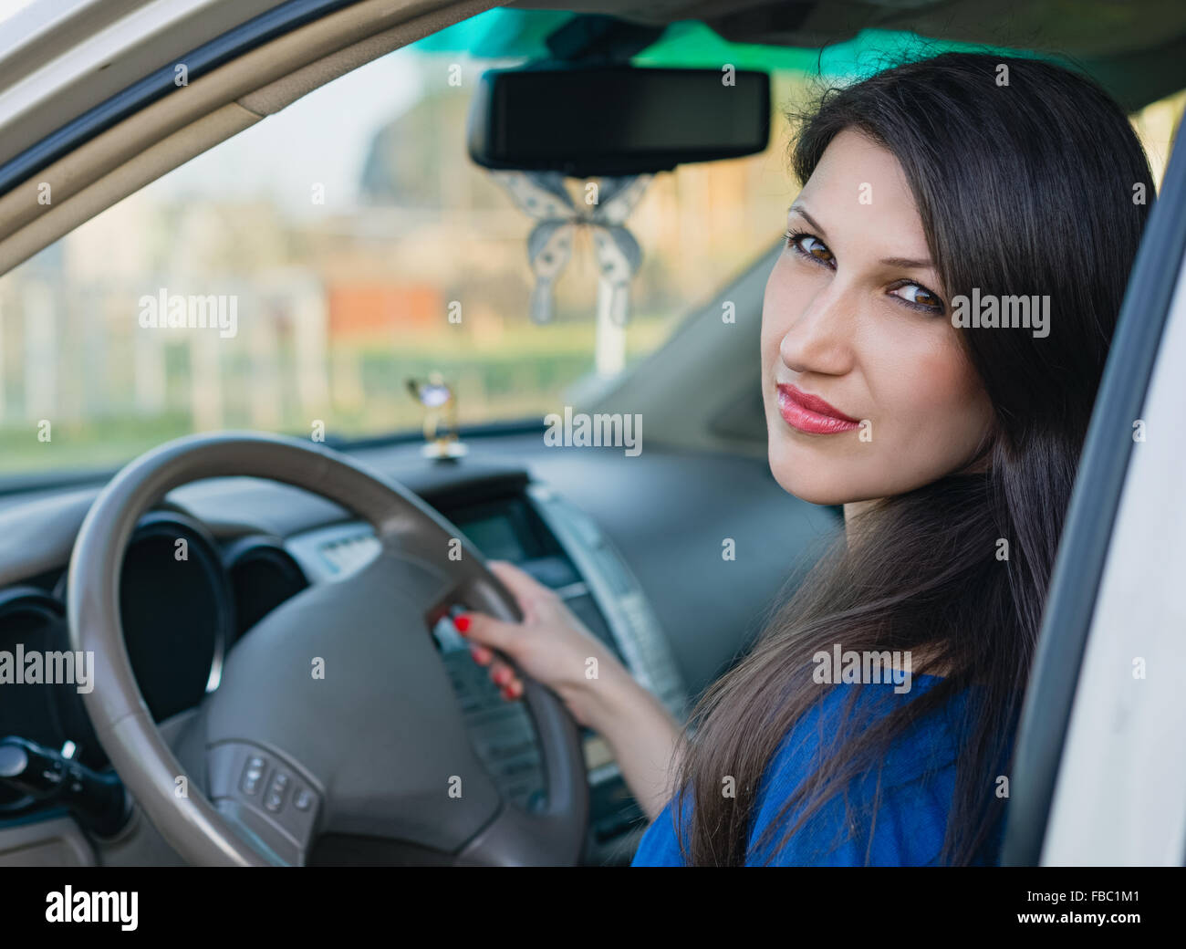 Portrait of a beautiful young woman driving a car Stock Photo - Alamy