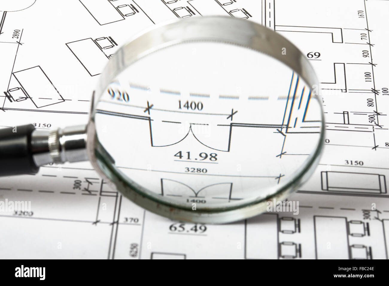 Magnifier on blueprints Stock Photo - Alamy