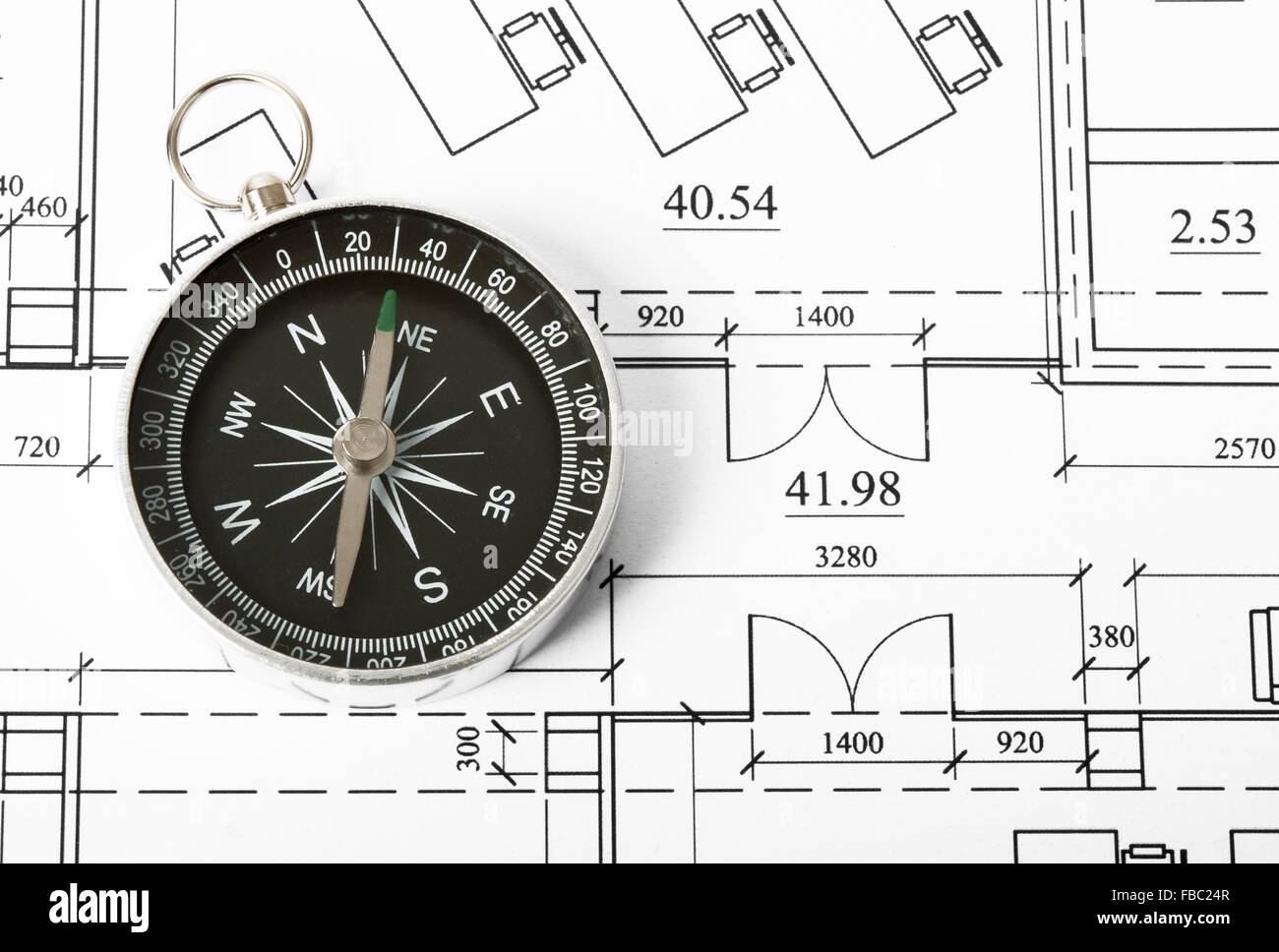 Compass with blueprints Stock Photo - Alamy