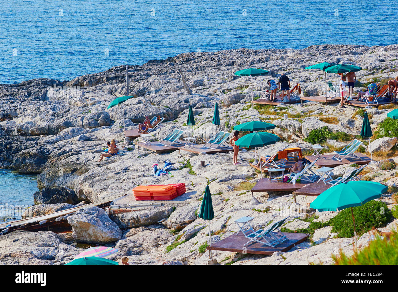 Sunbathers on rocks San Domino Isole Tremiti Puglia Apulia Italy Europe ...