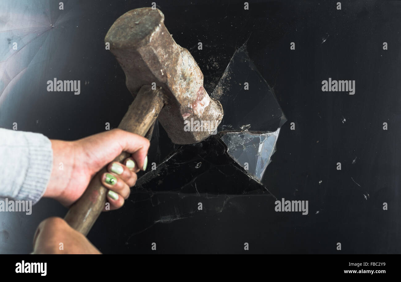 Closeup large metal hammer smashing black computer screen Stock Photo ...