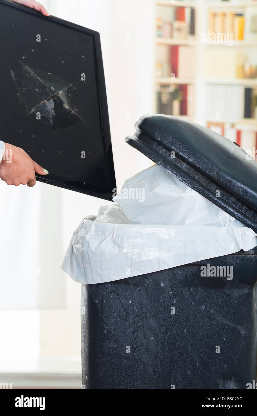 Broken computer screen going into large black trash dumpster Stock ...